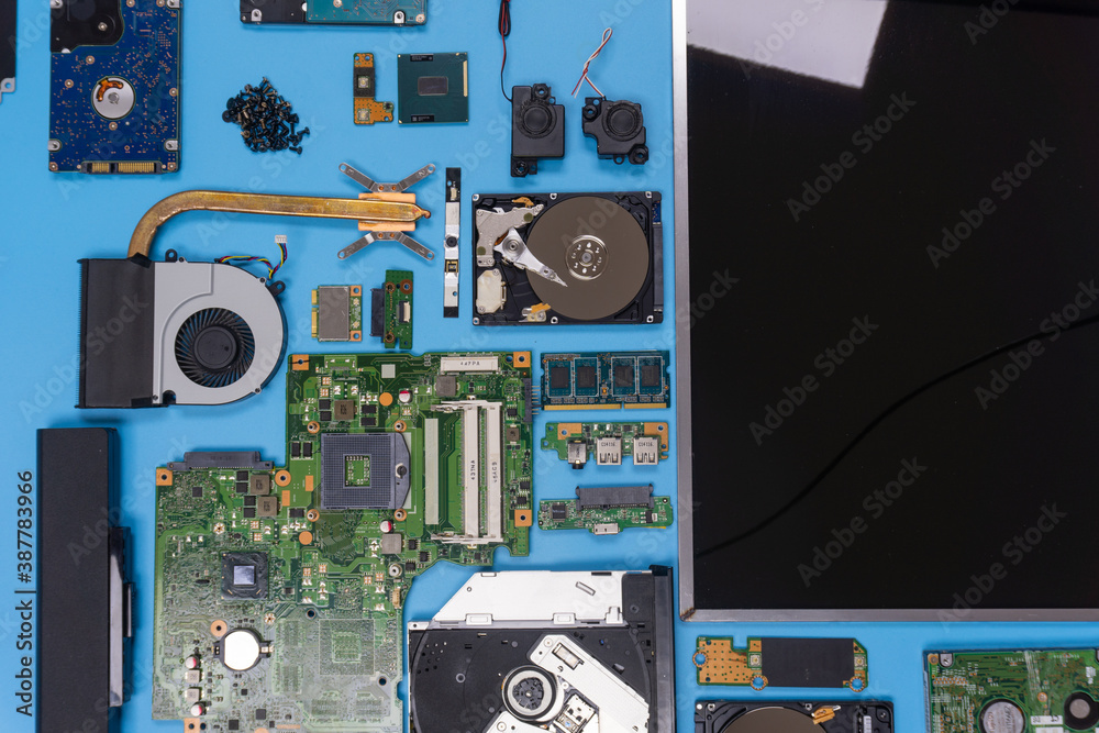 Parts of a modern computer. The insides of a laptop on a blue ...