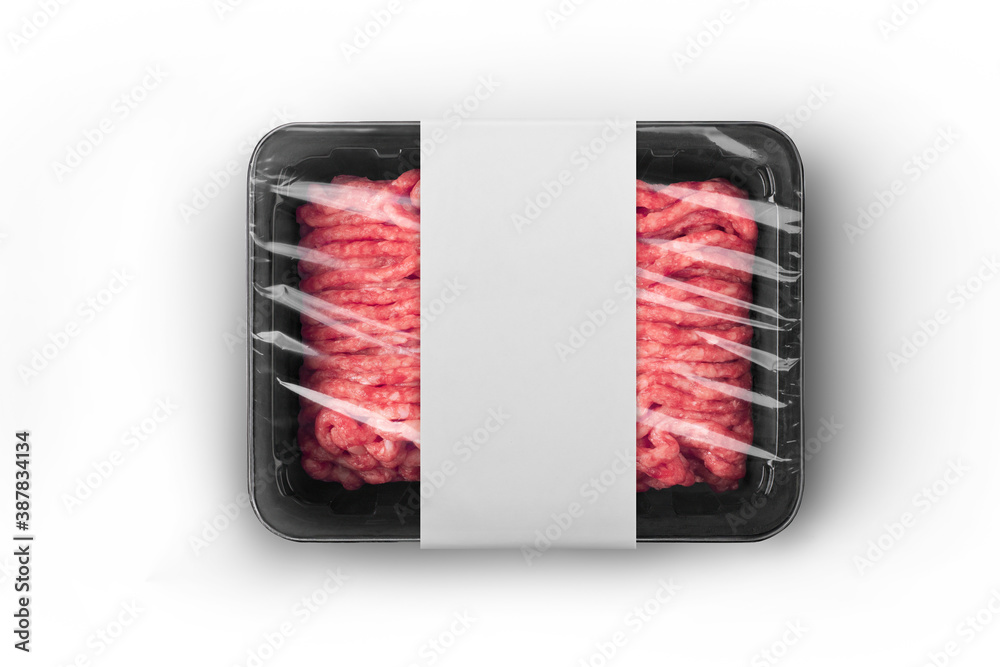 Black sealable plastic tray with white paper label filled with fresh ...