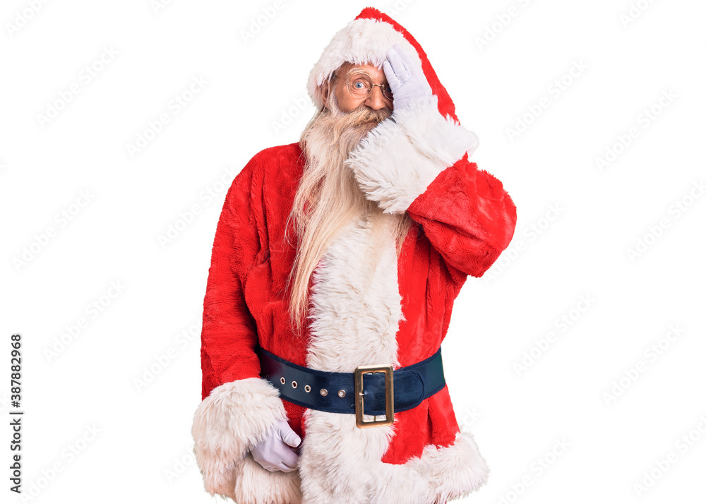 Old senior man with grey hair and long beard wearing traditional santa ...