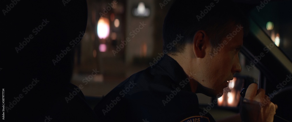 CU Police officer talking on CB radio while driving police vehicle ...