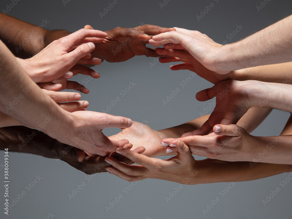 Save. Hands of people's crows in touch isolated on grey studio ...