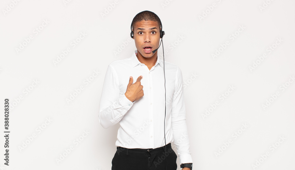 young black man looking shocked and surprised with mouth wide open, pointing to self Stock Photo ...