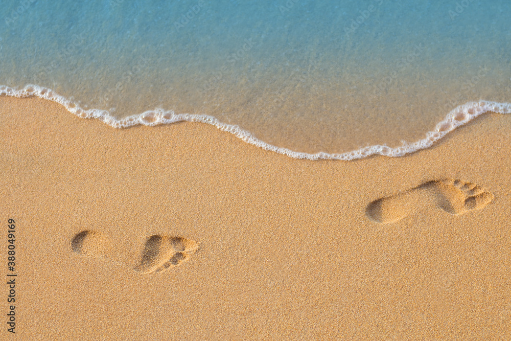 Texture background Footprints of human feet on the sand near the water ...
