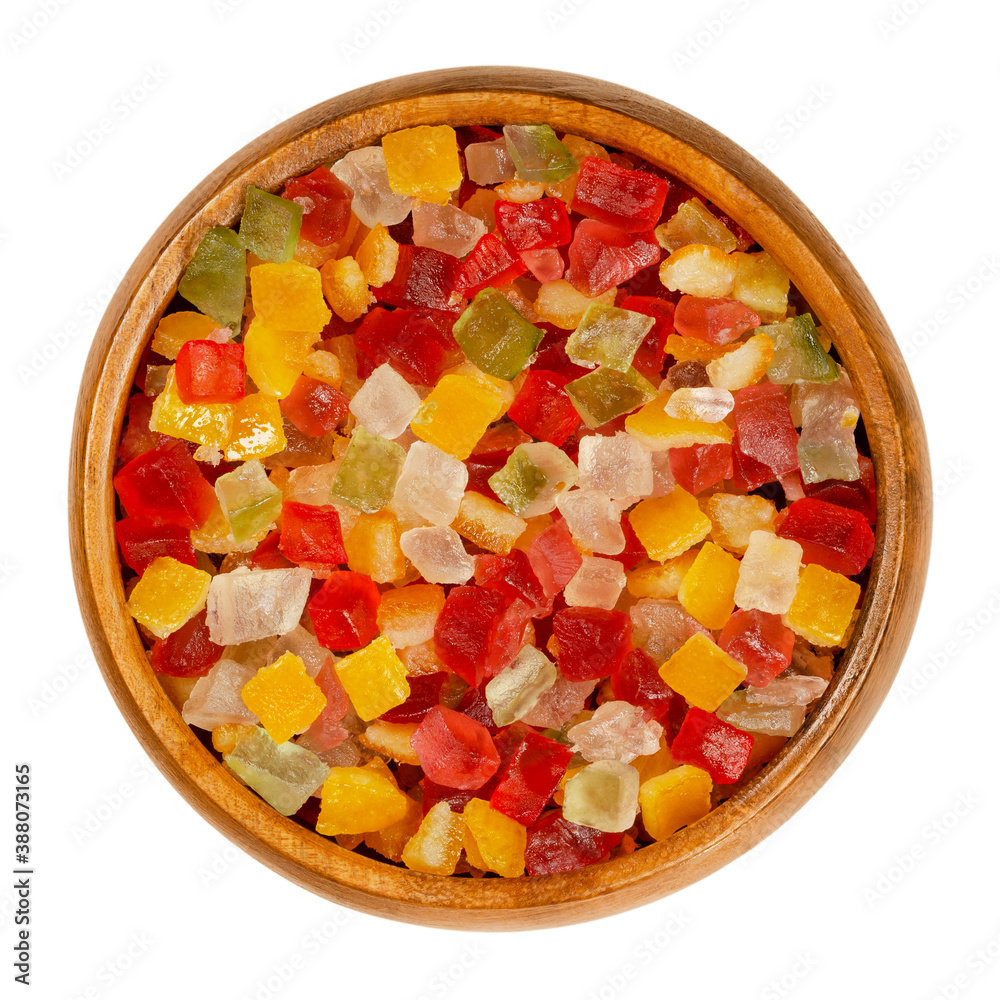 Diced candied fruits in a wooden bowl. Peel of oranges, papayas and ...