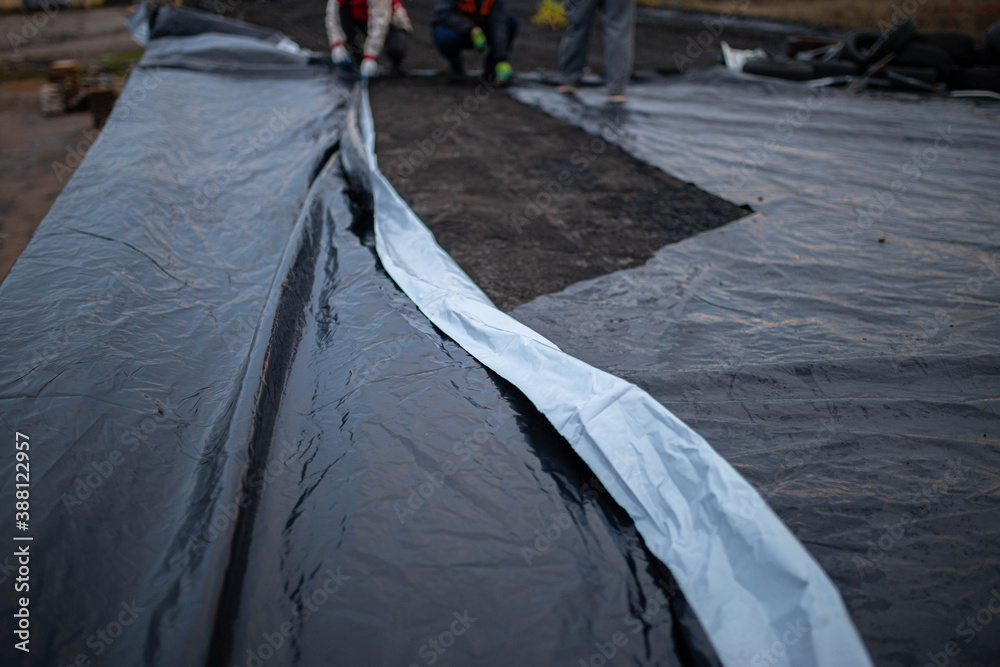 Roof waterproofing. Building construction. A waterproof film is applied ...