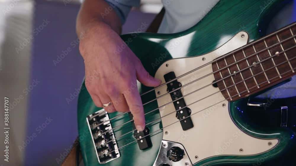 A young white man neatly dressed in black pants and blue shirt plays ...