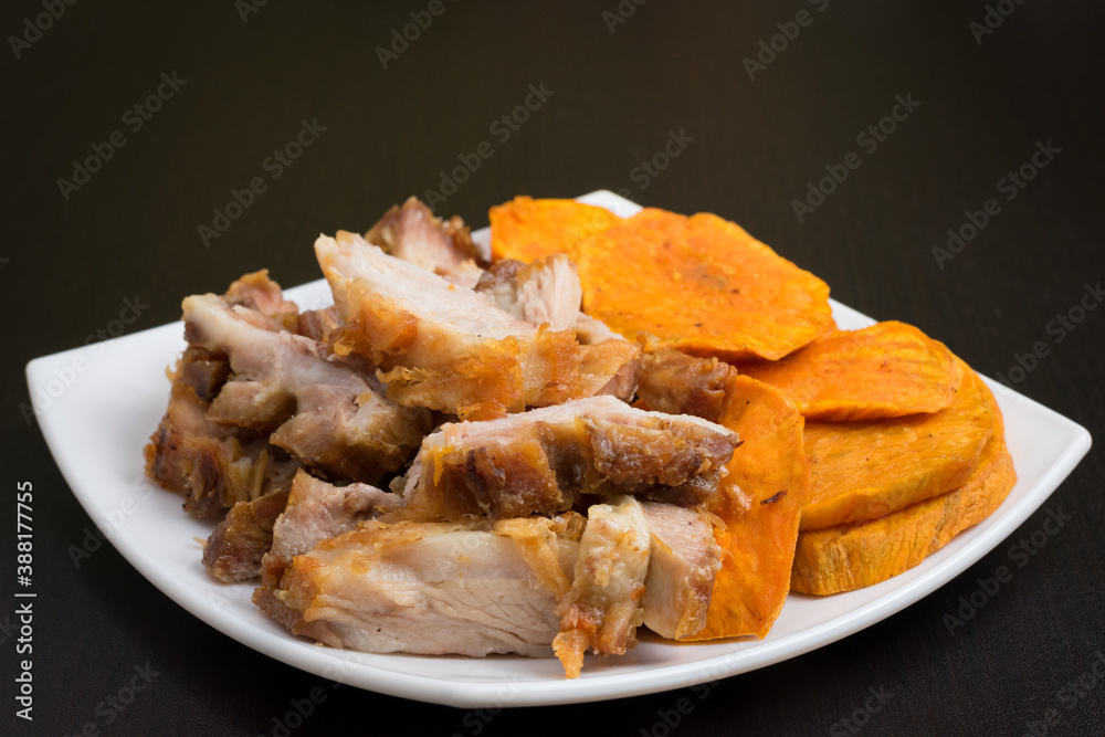 Porción de chicharron y camote frito Stock Photo | Adobe Stock