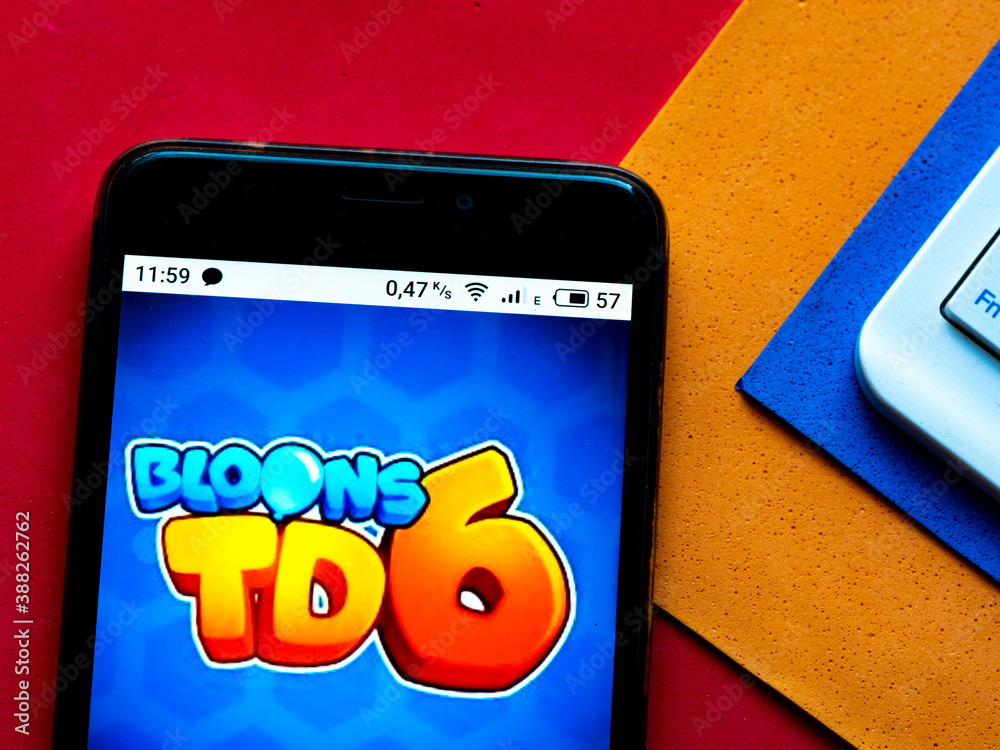 In this photo illustration a Bloons TD 6. appliance by Ninja Kiwi. logo ...