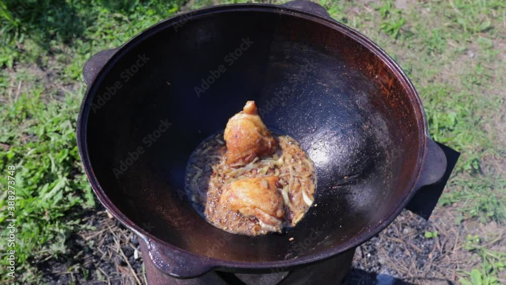 fried chicken in a cauldron with a golden brown crust in nature Stock ...