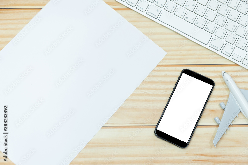 Top view of white screen smartphone ,blank paper sheet ,plane model and ...