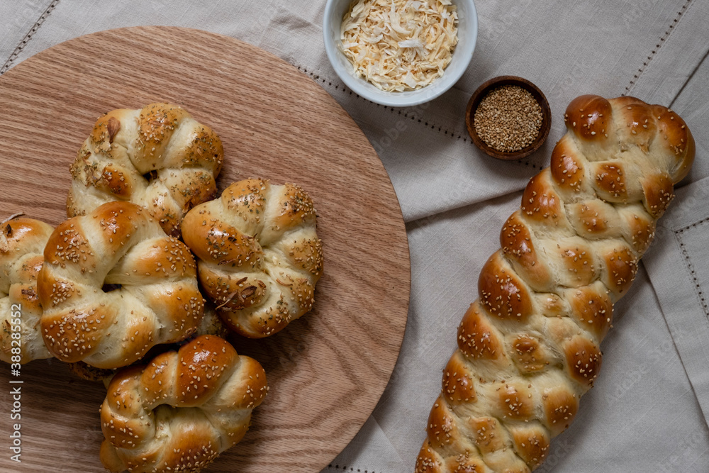 Variety of braided breads with sesame seeds on neutral backdrop. Stock ...