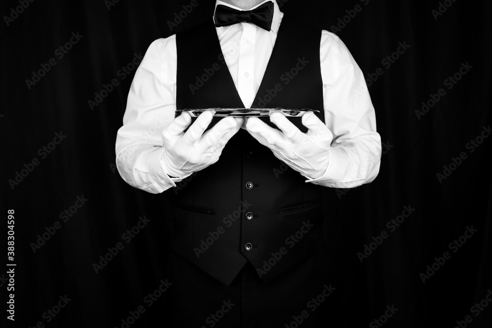 Portrait of Butler or Waiter in Black Vest and Bow Tie Holding Silver ...