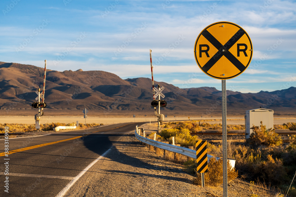 Image of a railroad crossing at the intersection of a highway in a ...