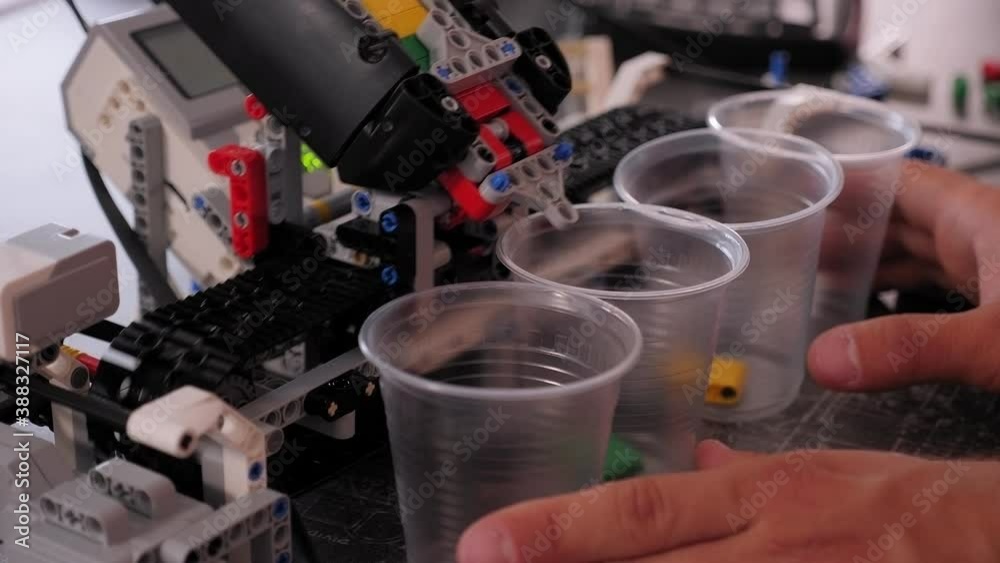 Close-up of a group of children playing with robots assembled from ...