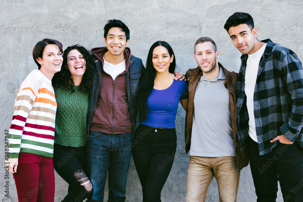 Multi ethnic group of young people together laughing and having fun ...