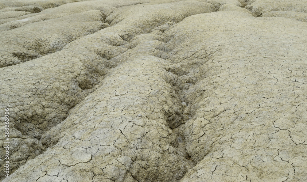Undulated water canal in dry soil texture. The Berca Mud Volcanoes is a ...