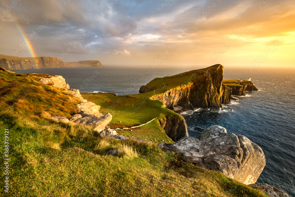 Iconic Isle of Skye lighthouse at Neist Point with beautiful golden ...