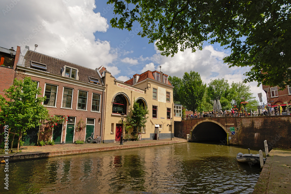 Embankments of `oudegracht` canal with typical brick stone houses and ...