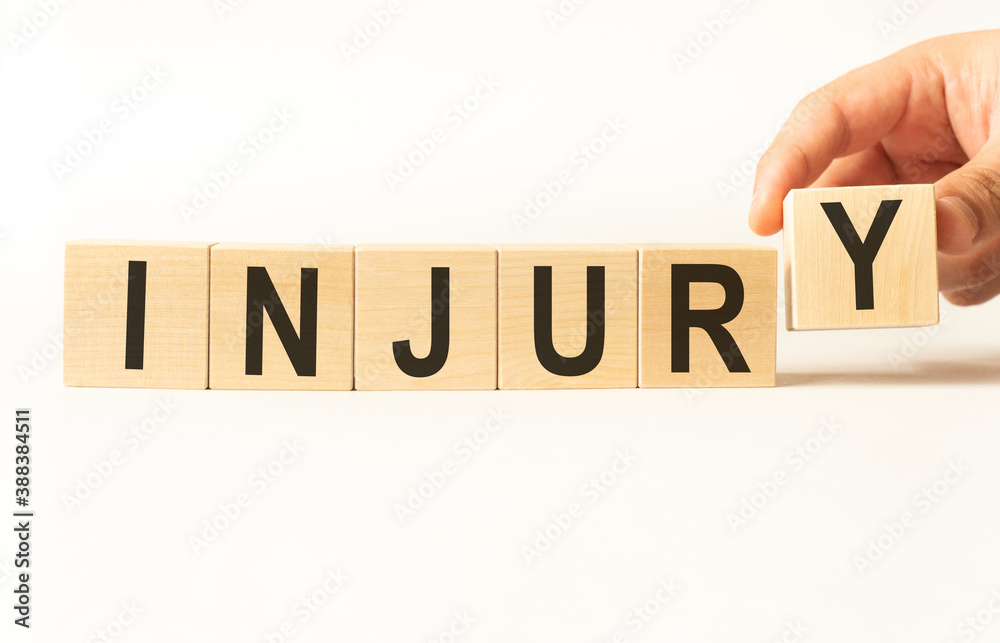 Word injury. Wooden small cubes with letters isolated on white ...