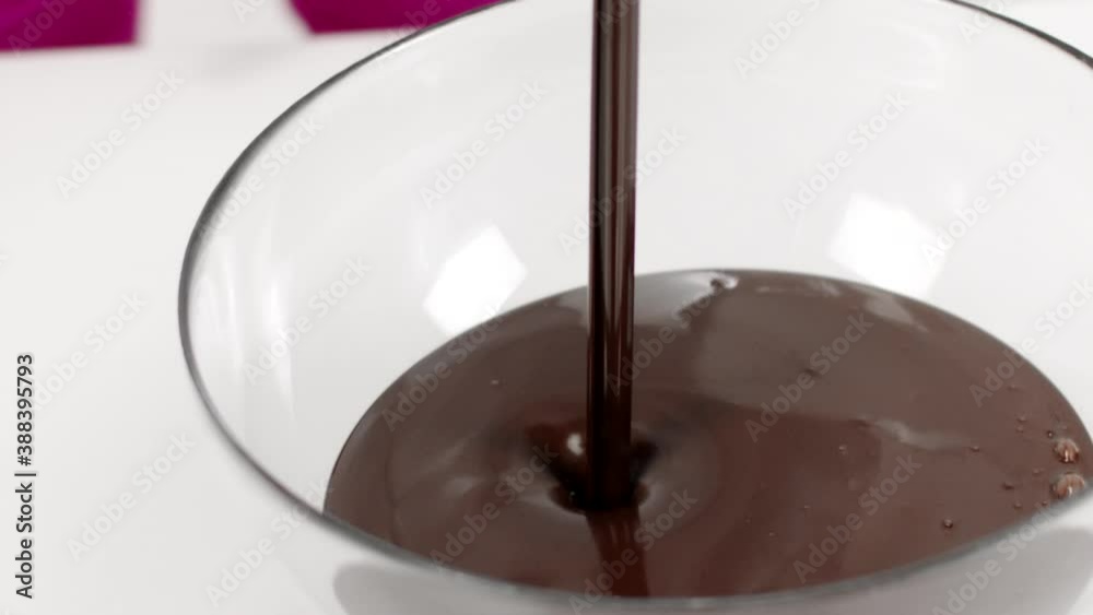 Video Stock Delicious premium dark chocolate liquid pouring into glass ...