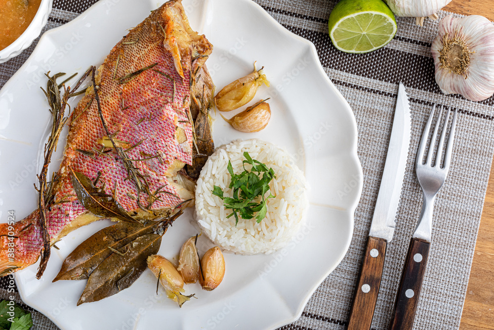 Roasted red fish (Olho de Cão in Brazil) seasoned with herbs, garlic ...