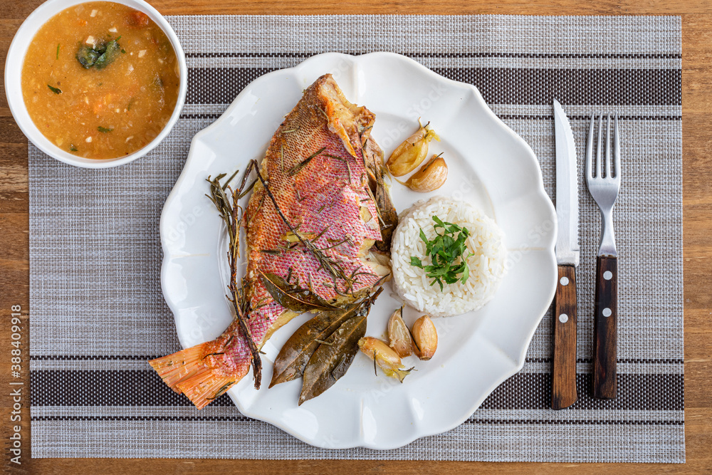 Roasted red fish (Olho de Cão in Brazil) seasoned with herbs, garlic ...