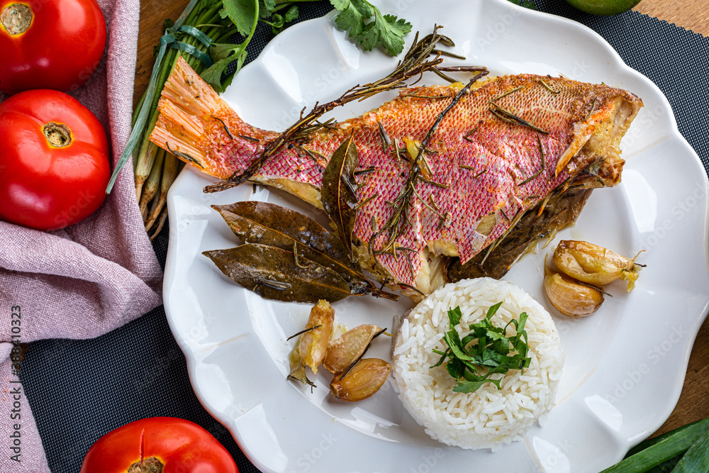 Roasted red fish (Olho de Cão in Brazil) seasoned with herbs, garlic ...