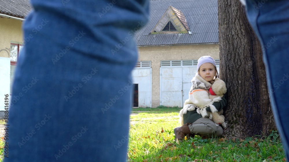 Mistreated child. Little girl with teddy bear is scared. Child in ...
