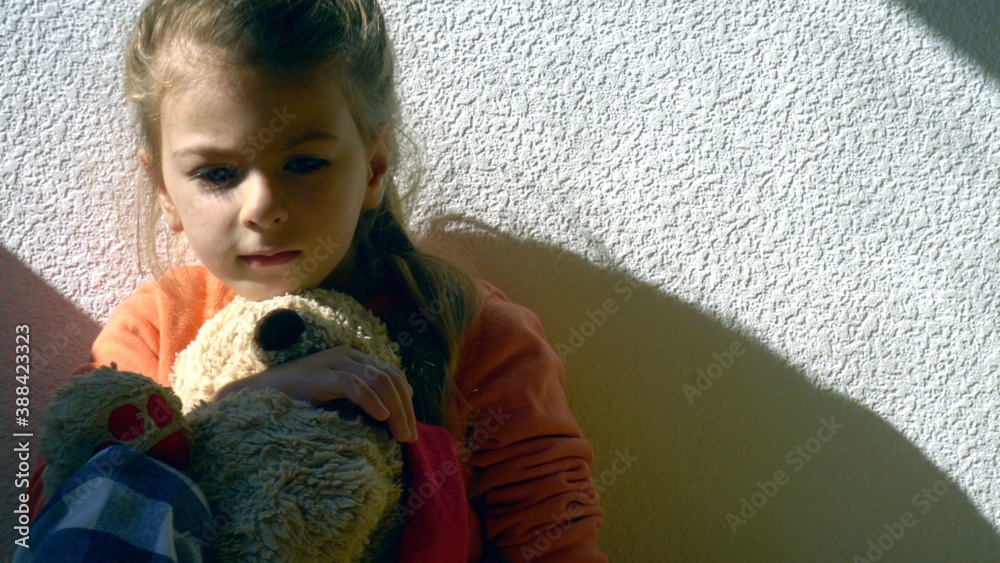 Mistreated child. Little girl on the floor sad. Child abuse concept ...