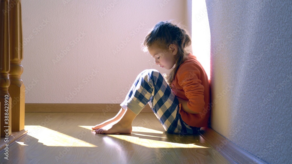 Mistreated child. Little girl on the floor sad. Child abuse concept ...