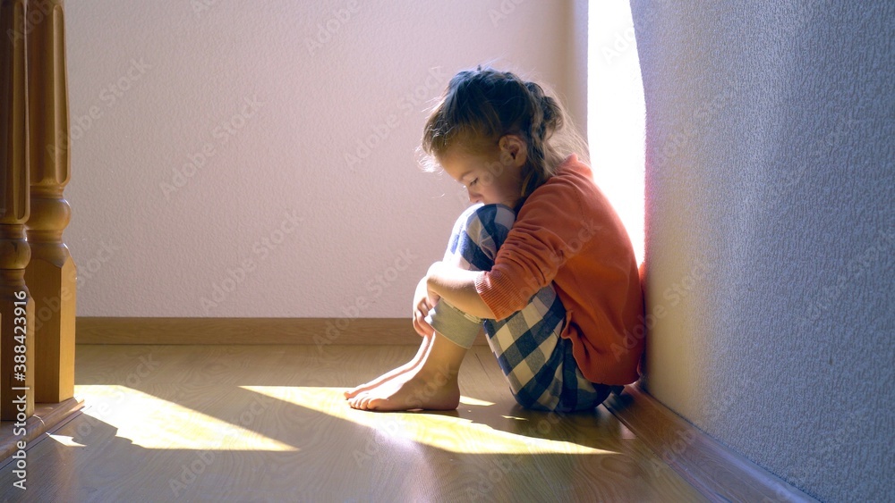 Mistreated child. Little girl on the floor sad. Child abuse concept ...