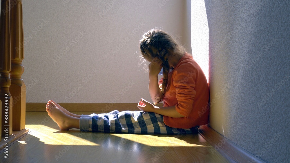 Mistreated child. Little girl on the floor sad. Child abuse concept ...