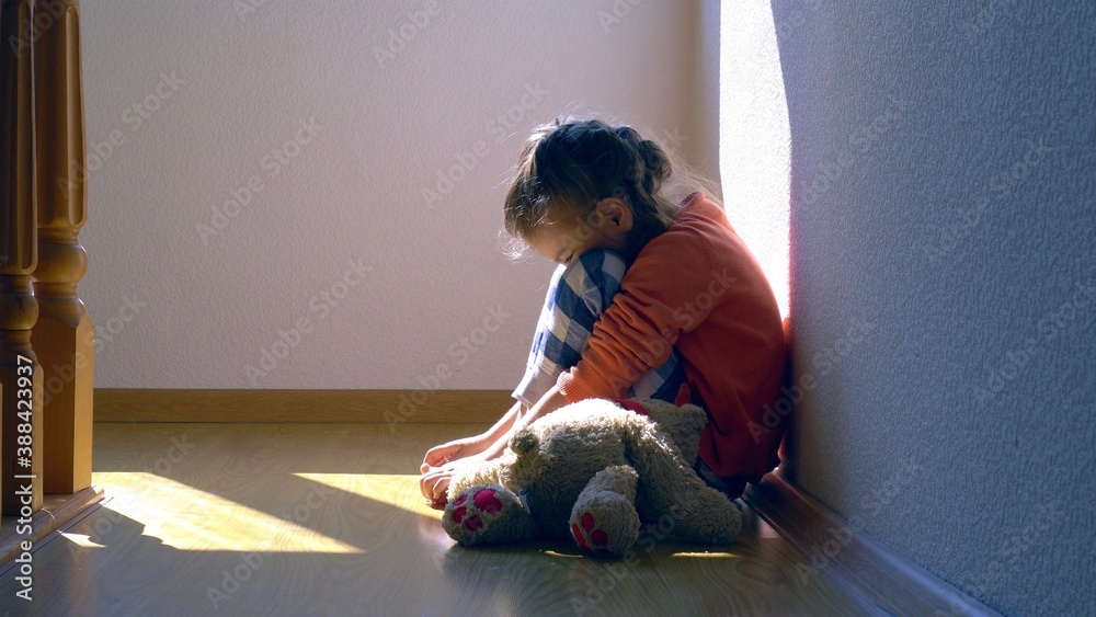 Mistreated child. Little girl on the floor sad. Child abuse concept ...