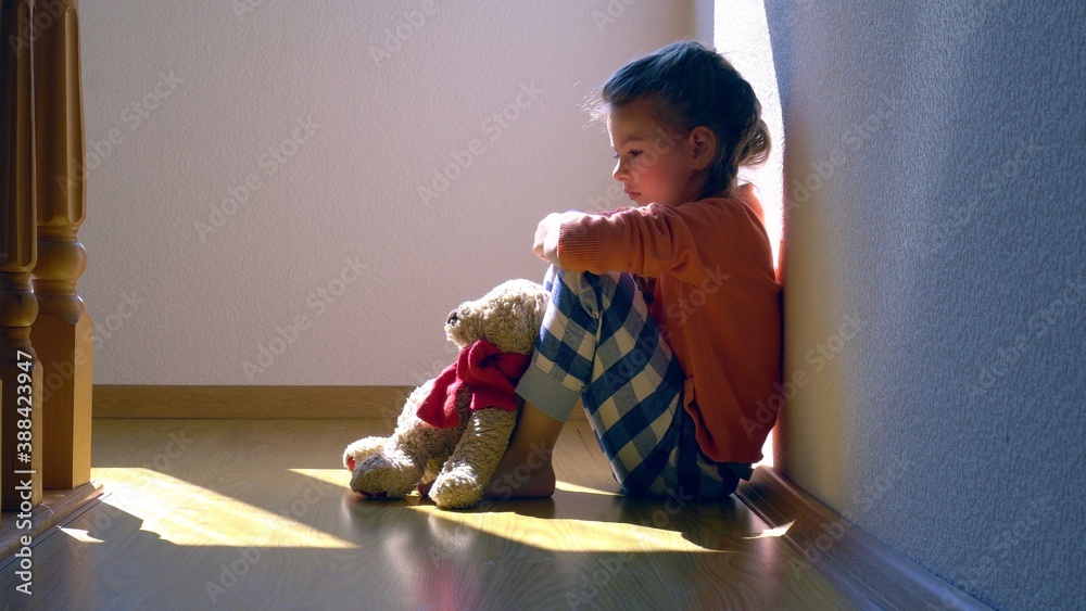 Foto de Mistreated child. Little girl on the floor sad. Child abuse ...