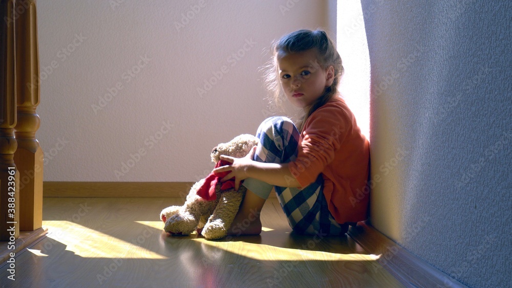 Mistreated child. Little girl on the floor sad. Child abuse concept ...