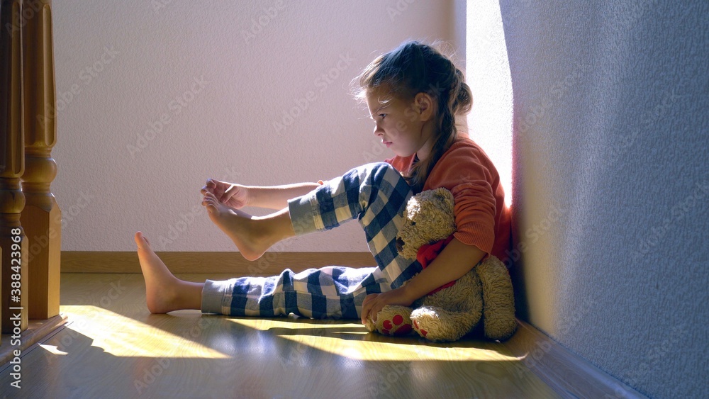 Mistreated child. Little girl on the floor sad. Child abuse concept ...