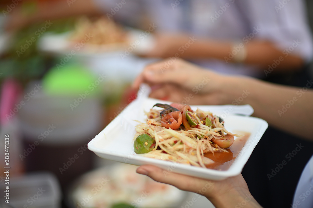 Focus of Som Tum Poo, Thai green papaya salad with black crabs in fome ...