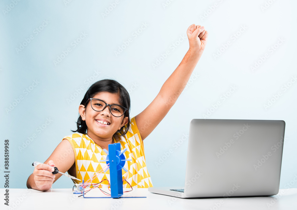 Electronic experiment - Indian girl student working with wires and ...