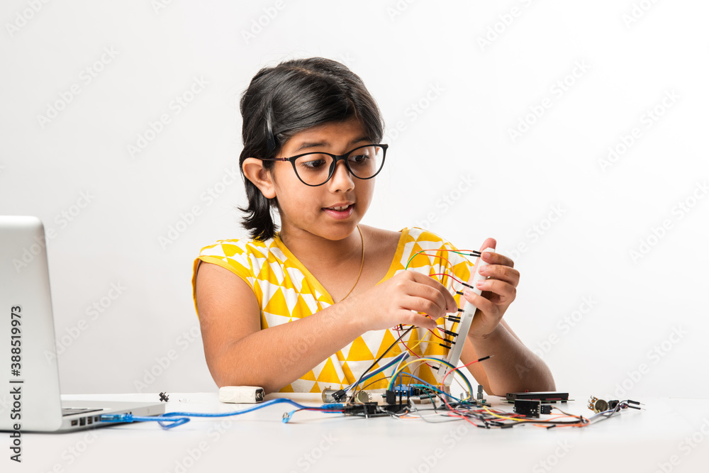 Electronic experiment - Indian girl student working with wires and ...