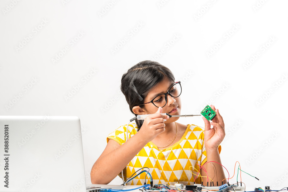 Electronic experiment - Indian girl student working with wires and ...
