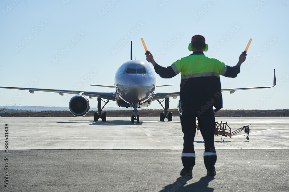 The runway traffic controller uses gestures and sticks to help the ...