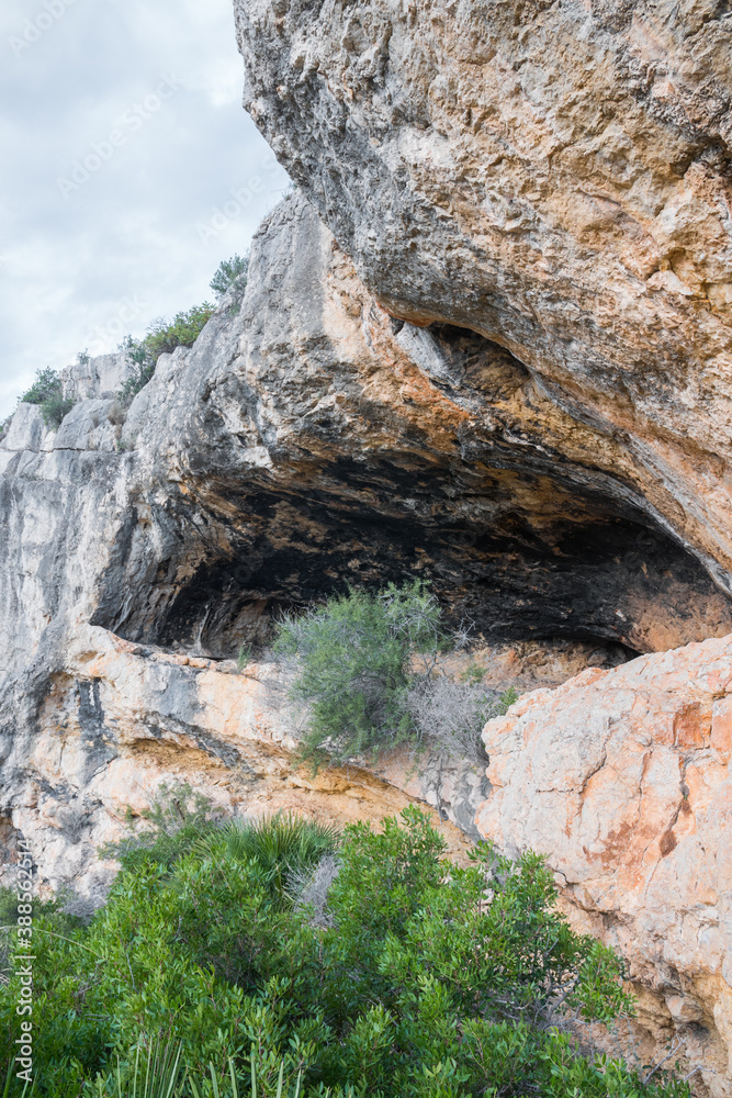 Beautiful natural cave on a cliff. Prehistoric excavation. Neanderthal ...