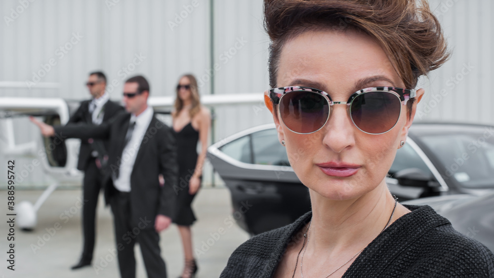 Famous female celebrity with bodyguards surrounded. VIP security agents ...