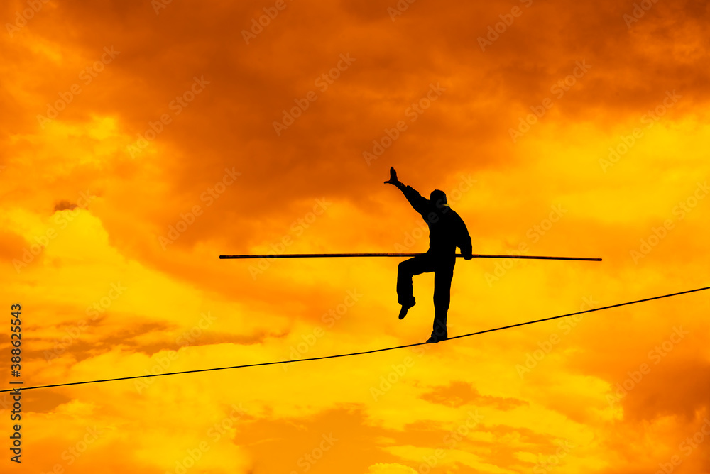 Wandering tightrope walker playing on sky background. Silhouette of ...