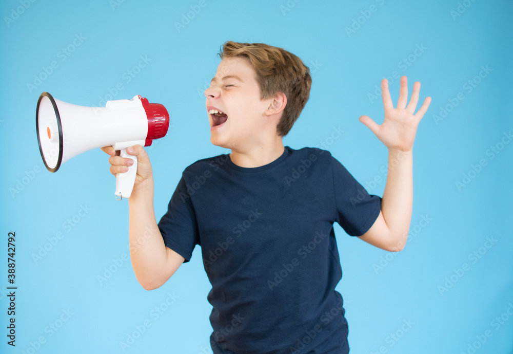 Cute little boy screaming in megaphone over blue background. Stock ...