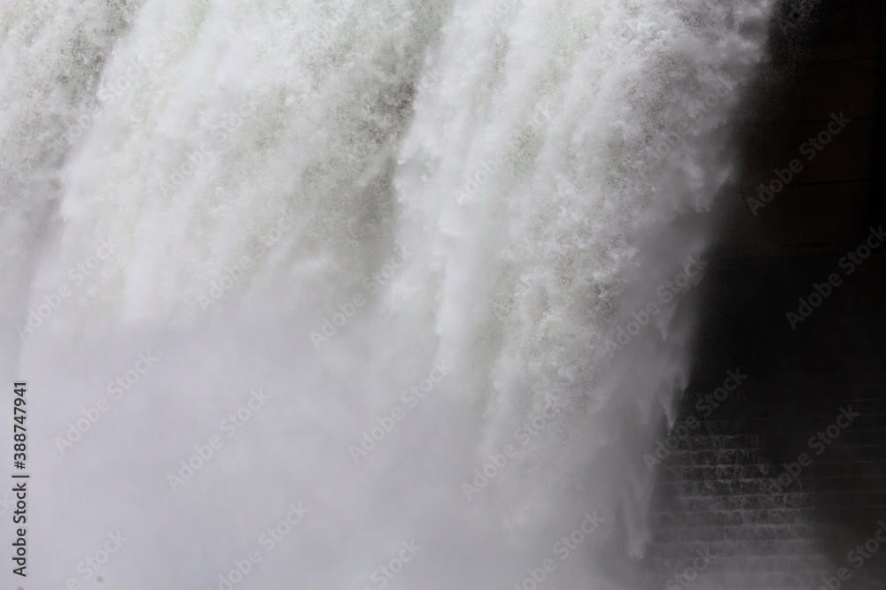 Water falling from the spillway of the concrete dam, it is overflow way ...