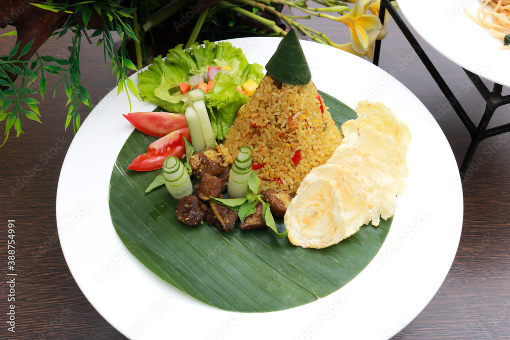 Foto de Traditional Indonesian Cuisine Nasi Tumpeng. Tumpeng is a cone ...