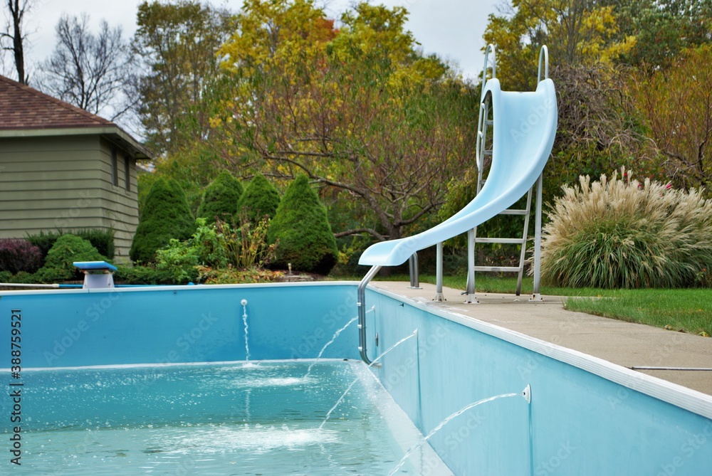 backyard swimming pool with diving board pool slide and ladder emptied ...