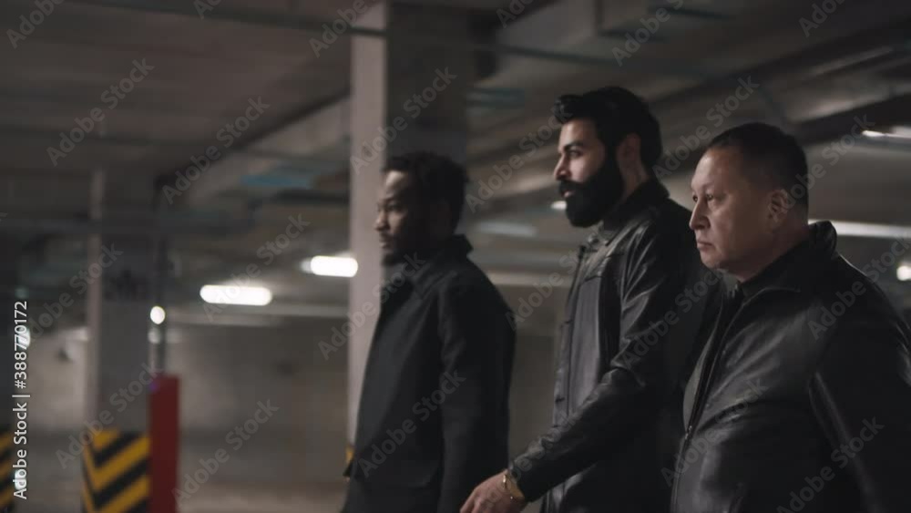 Side-view through columns footage of Eastern and Western assertive gang ...