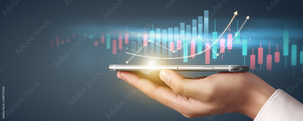 Smartphone in hand plan graph growth and increase of chart positive ...
